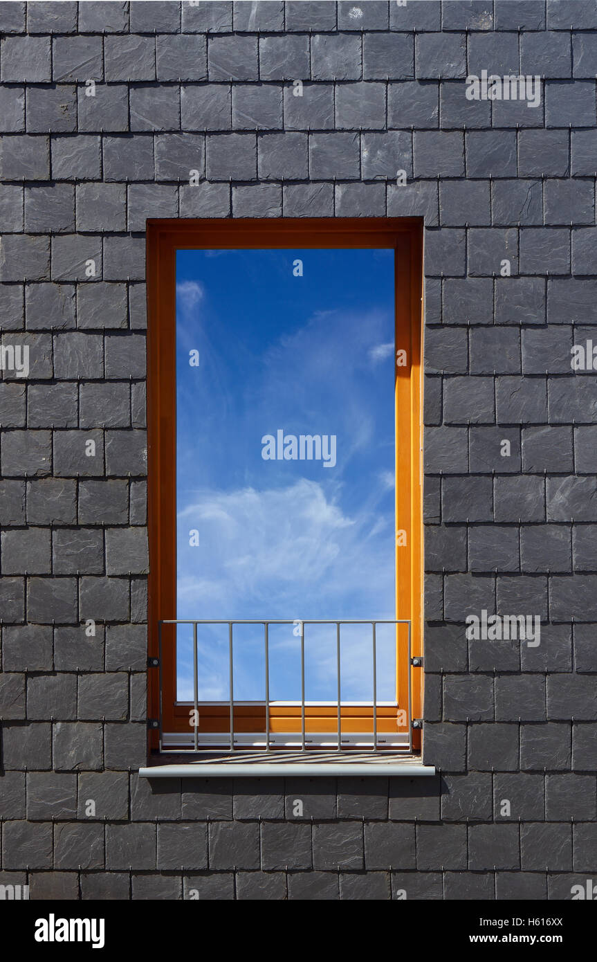 Wall from black granite square tiles and a modern plastic window in ...