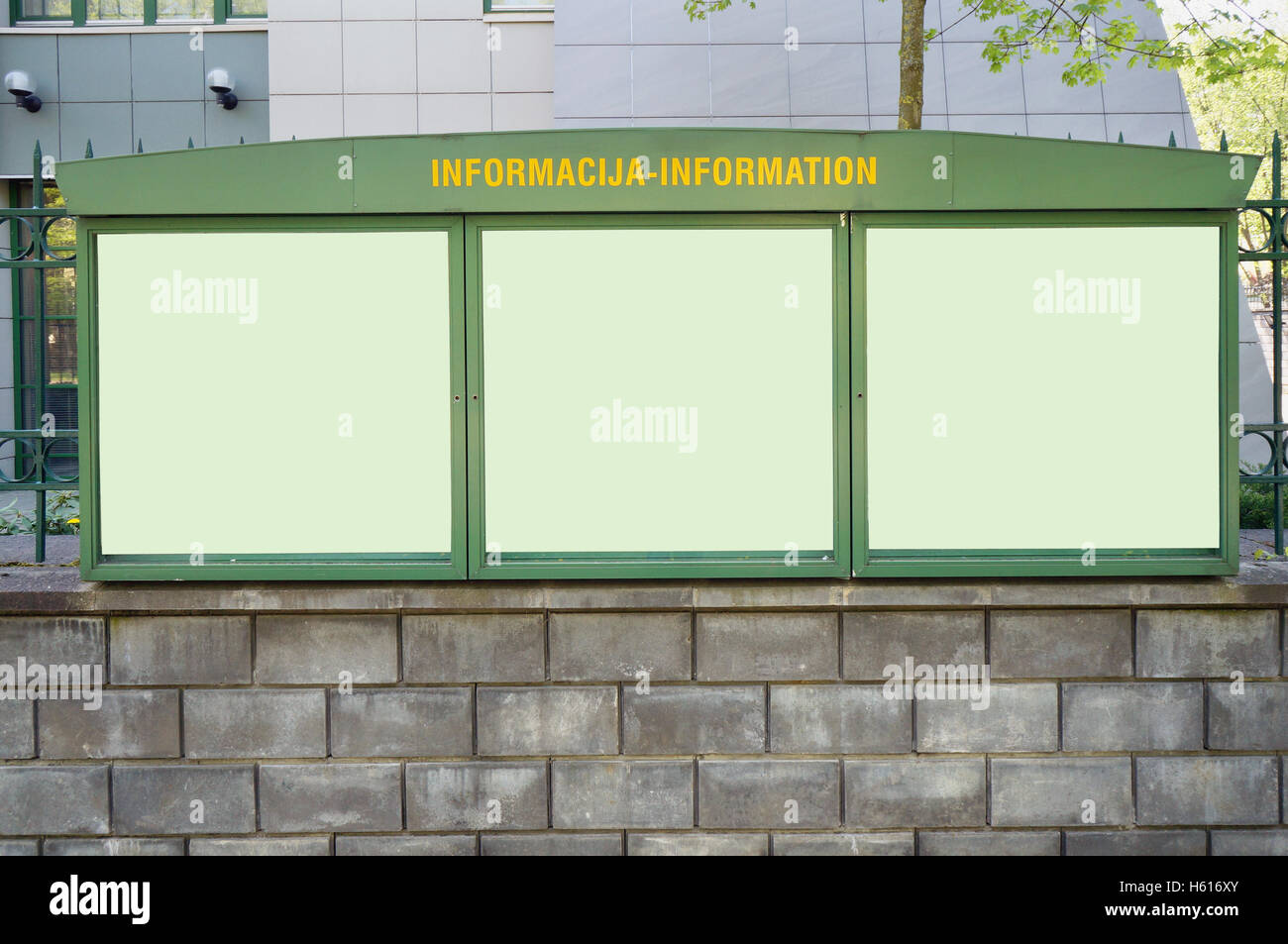 Green metal information billboard in city street. Emty area isolated ...