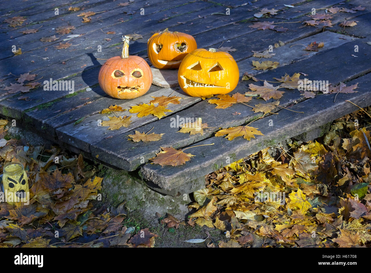 Halloween concept. Three terrible ugly pumpkins on a timber aged floor ...