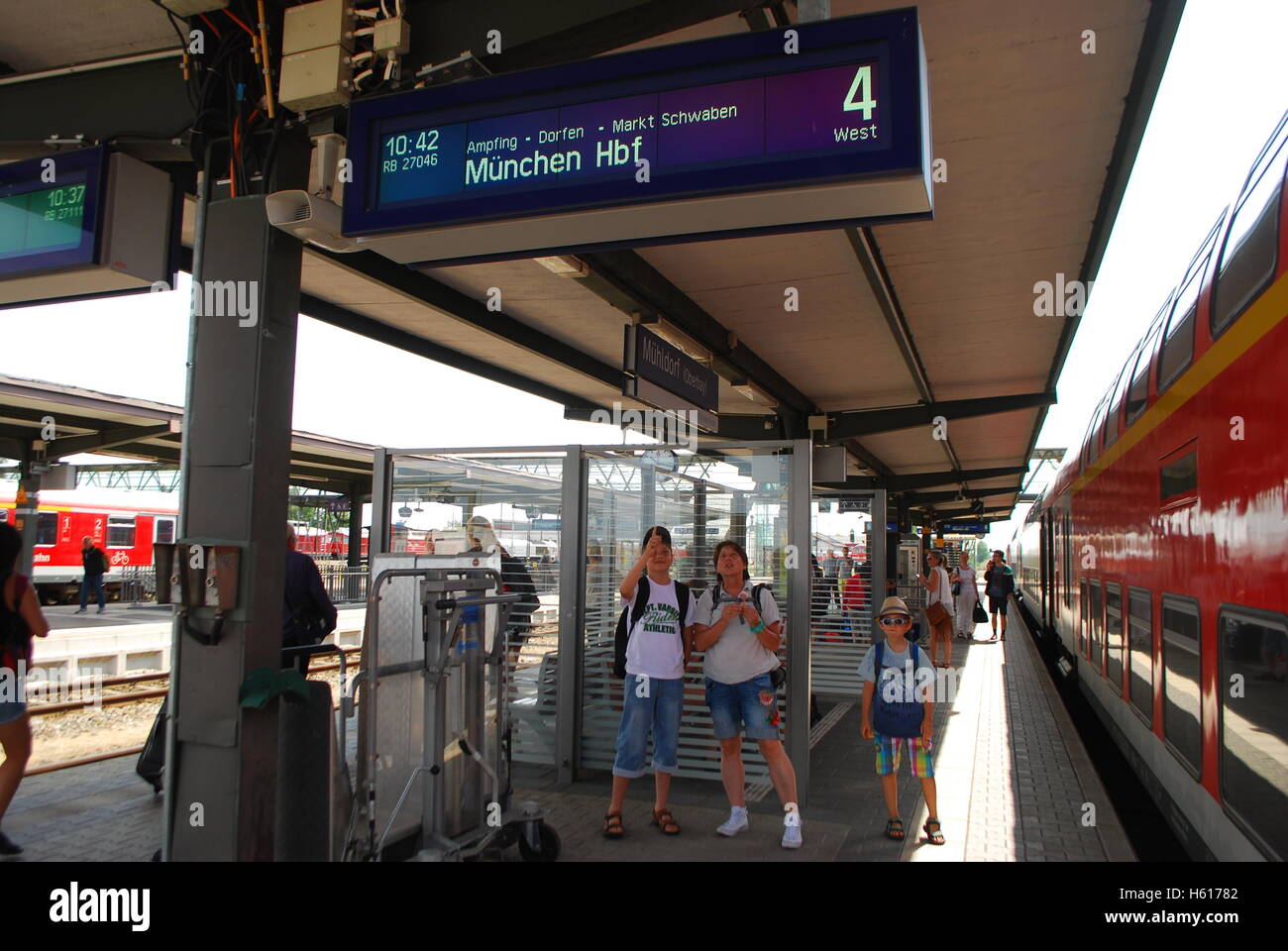 Family looks at train destination sign Stock Photo - Alamy