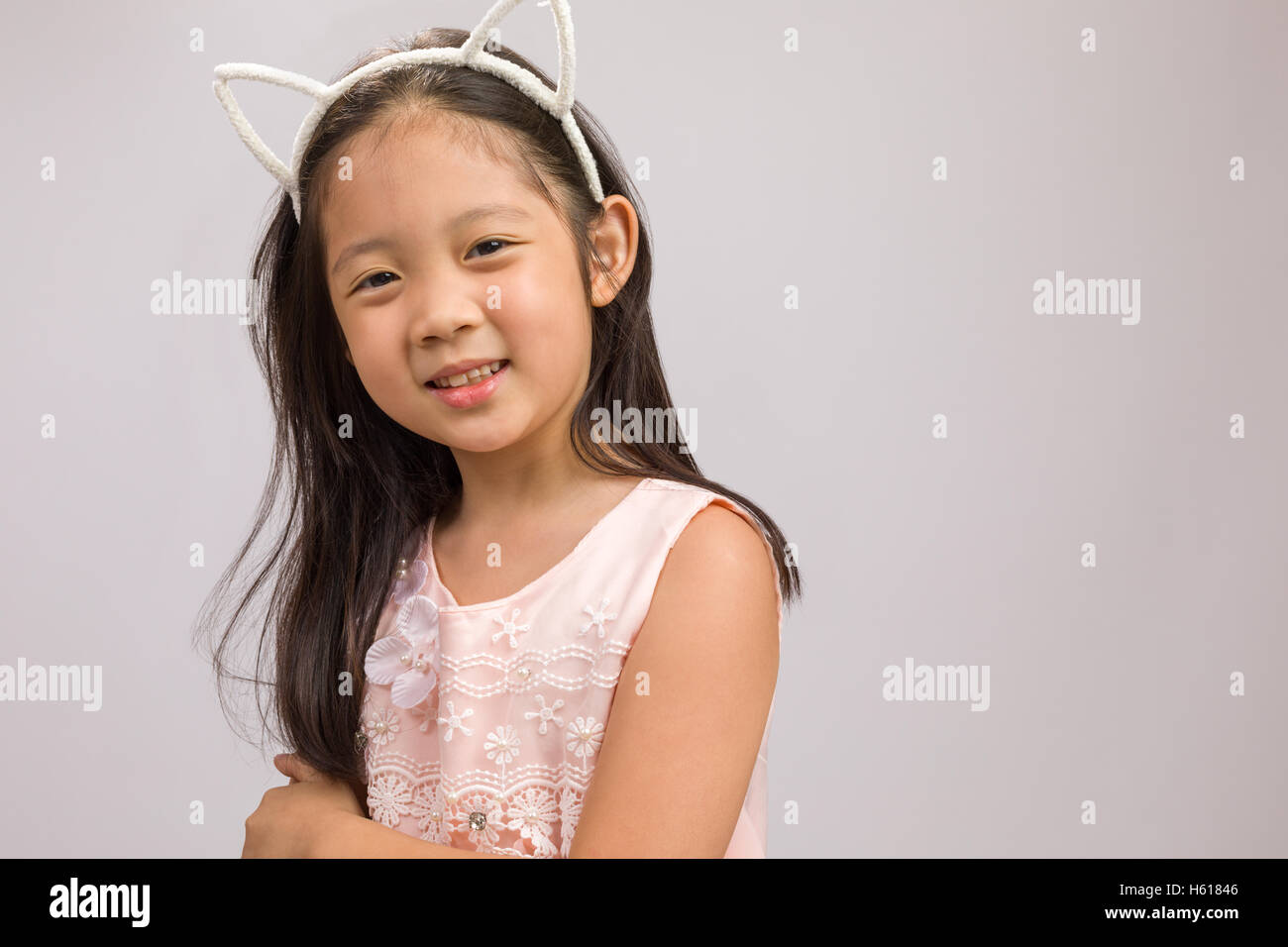 Child with cat ear headband, isolated on white background Stock Photo ...