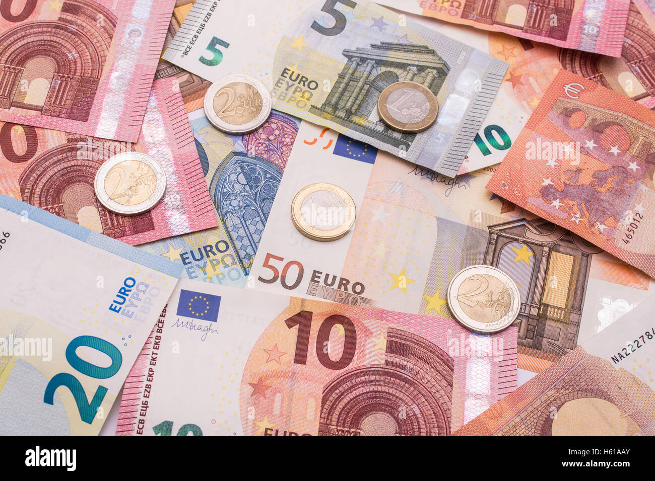 Earnings and salary of euro notes and coins Stock Photo - Alamy