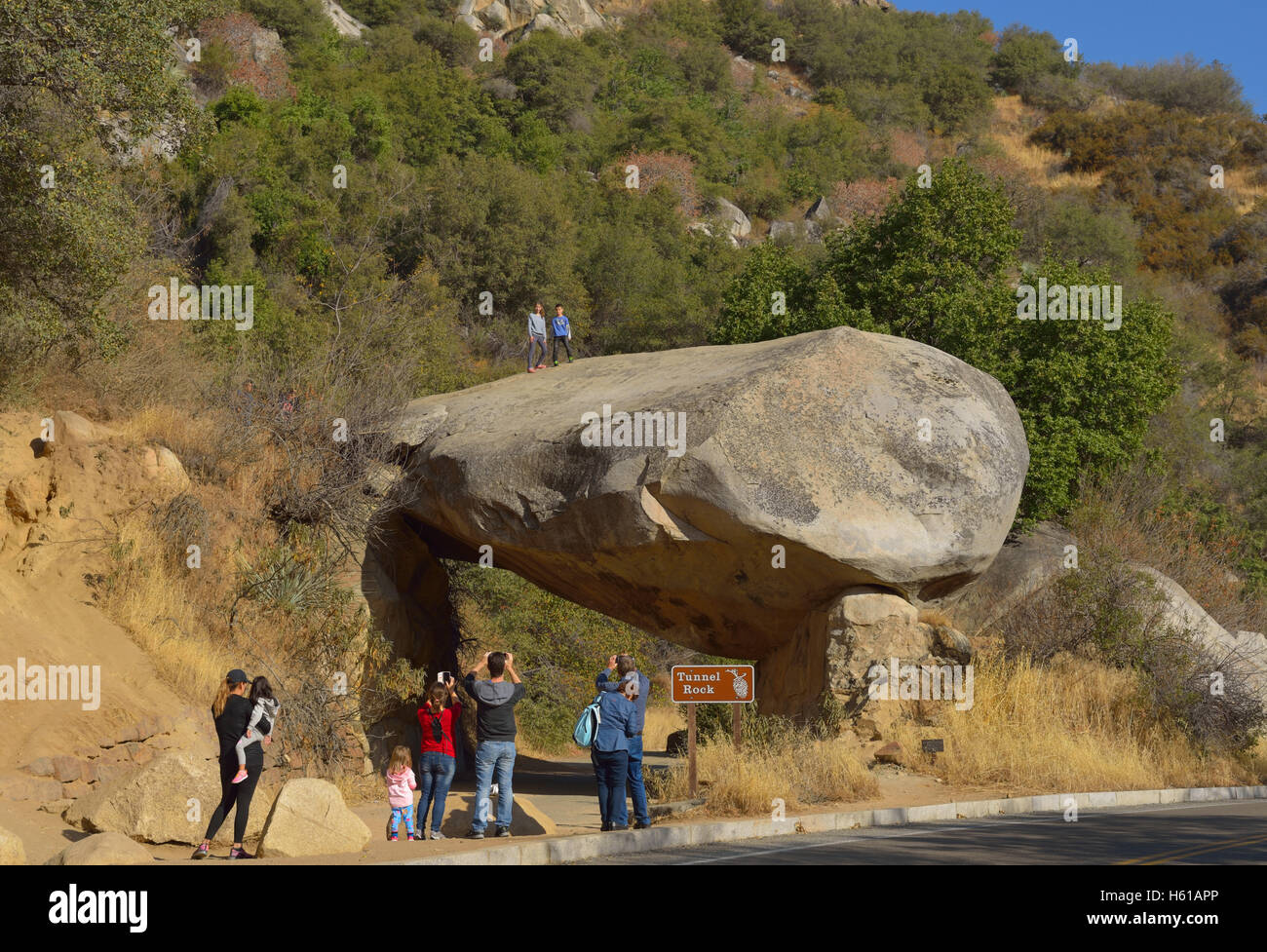 Tourists exploring the Tunnel Rock on Generals Highway, Sequoia ...
