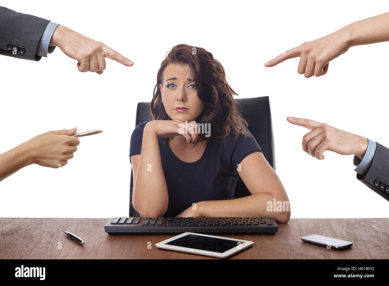 business woman sitting at desk surrounded by pointing fingers Stock ...