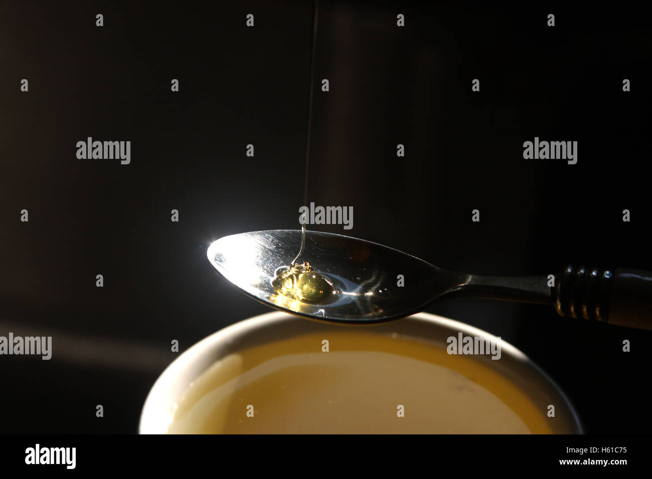 Spoon filled up with honey hi-res stock photography and images - Alamy