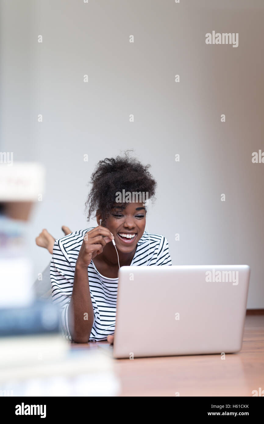 Happy African American woman with a lovely frizzy afro hairdo lying on ...