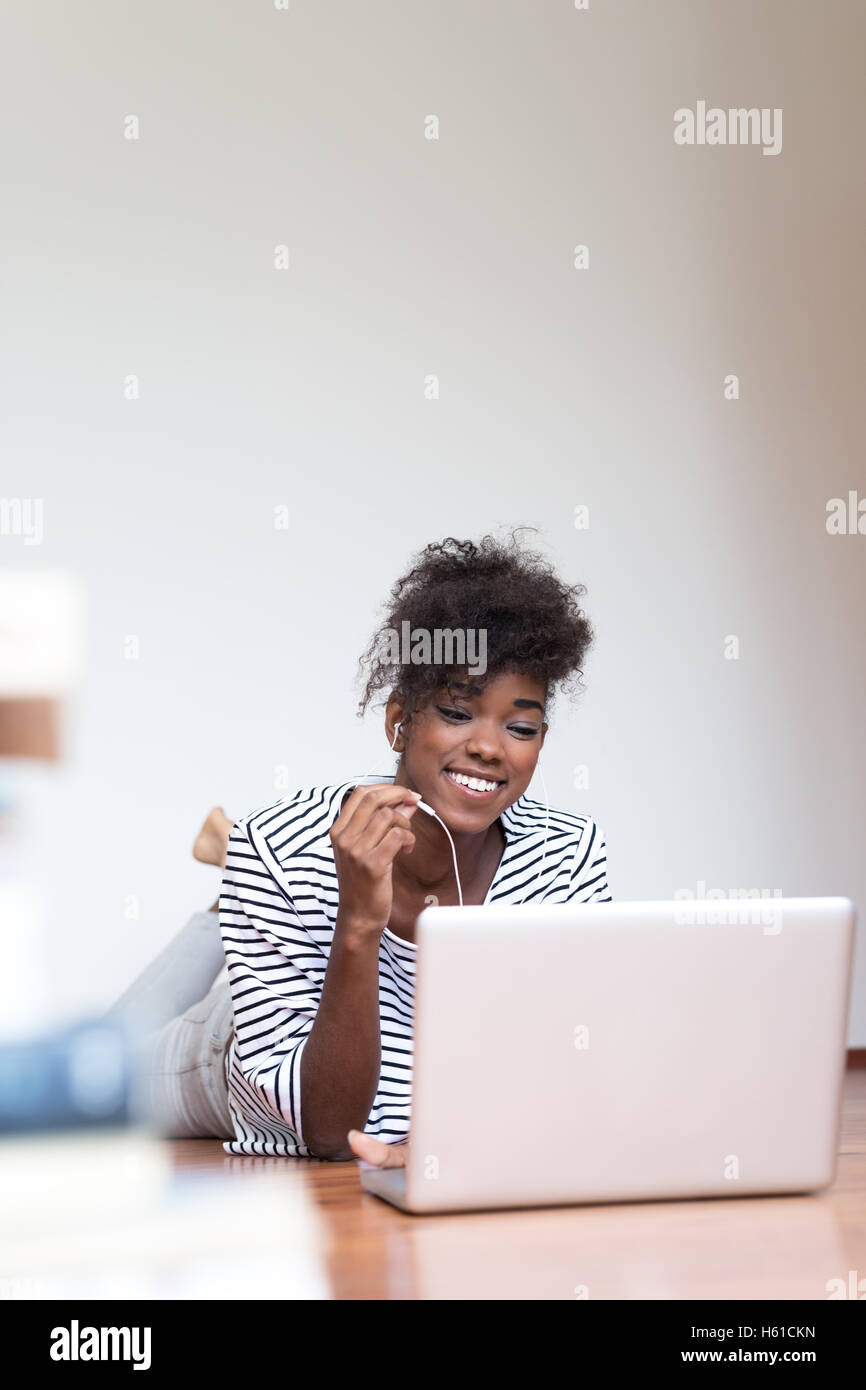 Happy African American woman with a lovely frizzy afro hairdo lying on ...