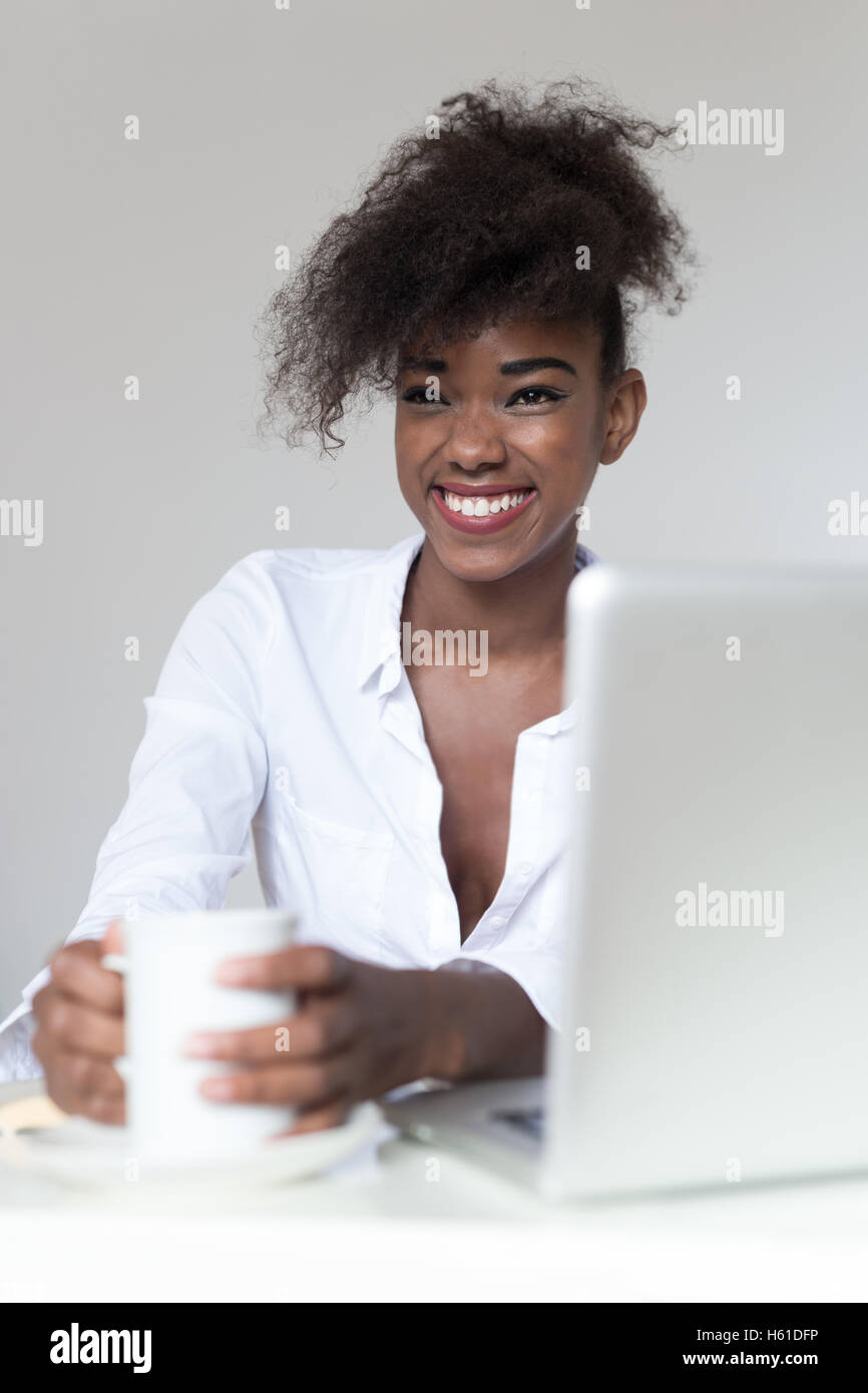 Happy contented young African American woman with an afro hairstyle ...