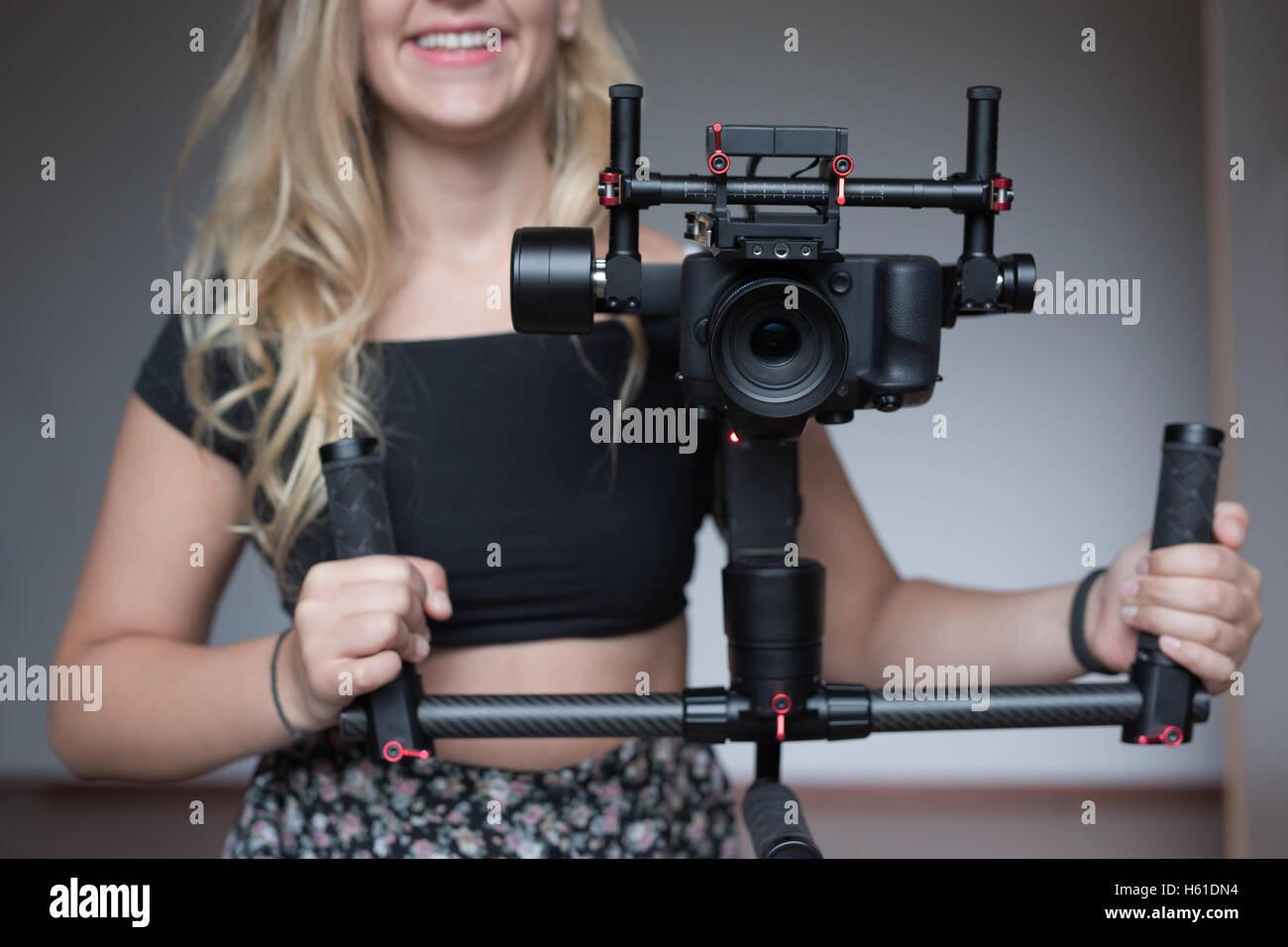 Professional woman videographer with gimball video slr Stock Photo - Alamy