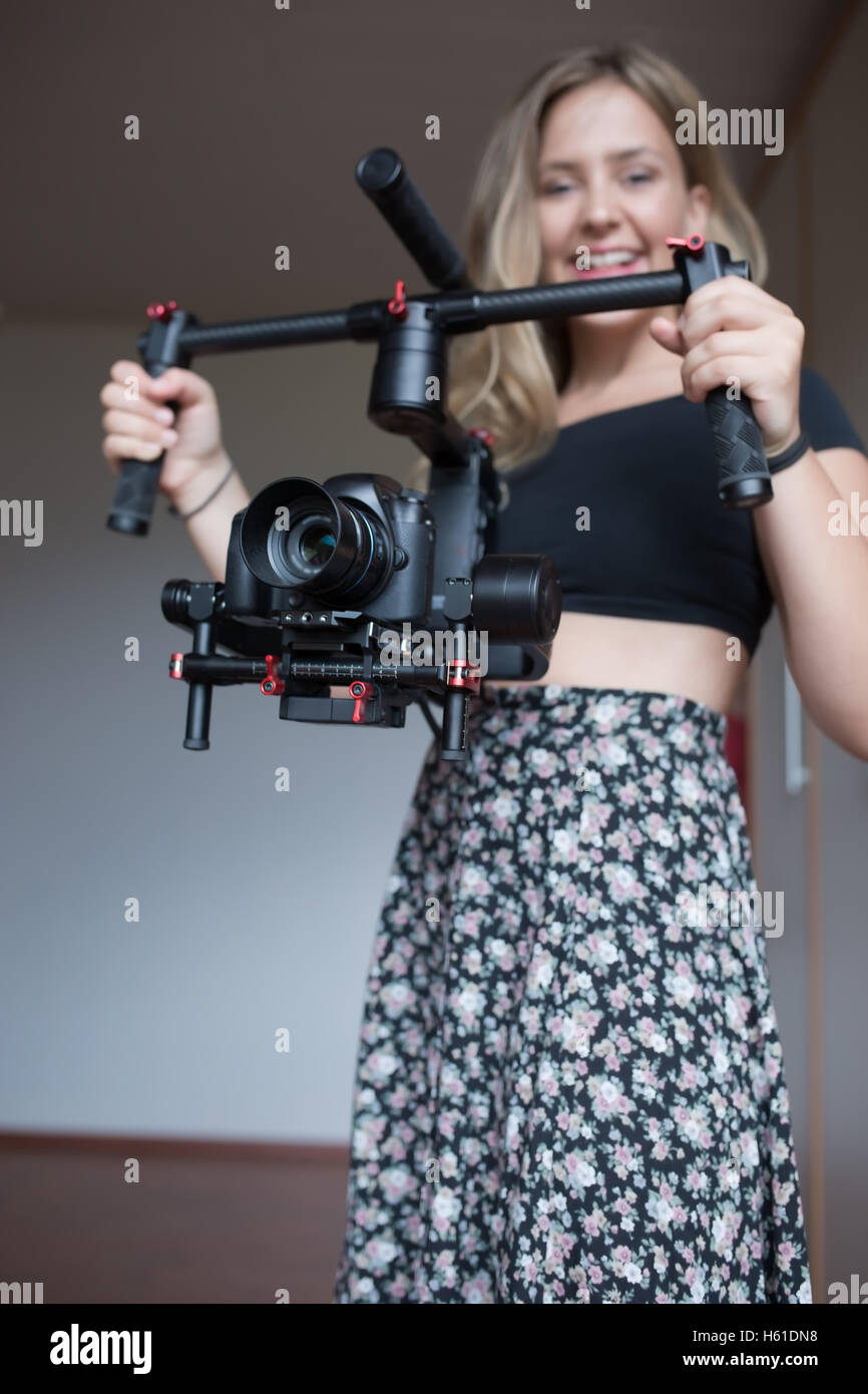 woman videographer with gimball video slr Stock Photo - Alamy