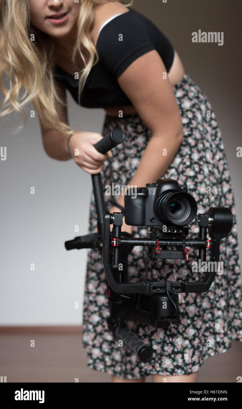 woman videographer with gimball video slr Stock Photo - Alamy