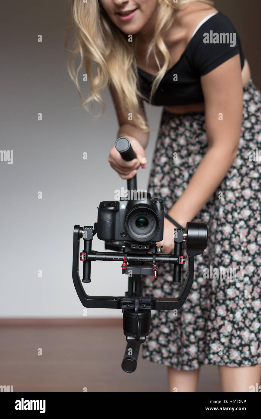 Professional woman videographer with gimball video slr Stock Photo - Alamy