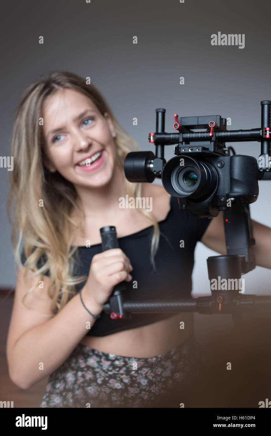 Professional woman videographer with gimball video slr Stock Photo - Alamy