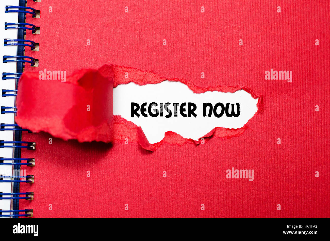The word register now appearing behind torn paper Stock Photo - Alamy