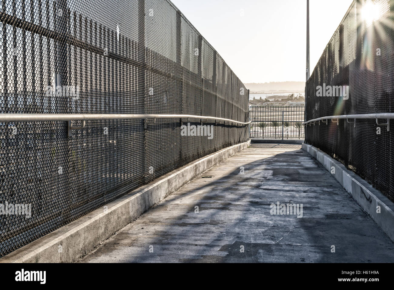 concrete walkway, chain link fence Stock Photo - Alamy