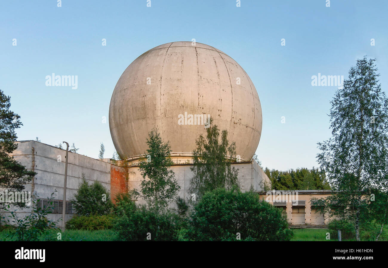 Old big dome of a radar antenna on the roof of the building of a ...