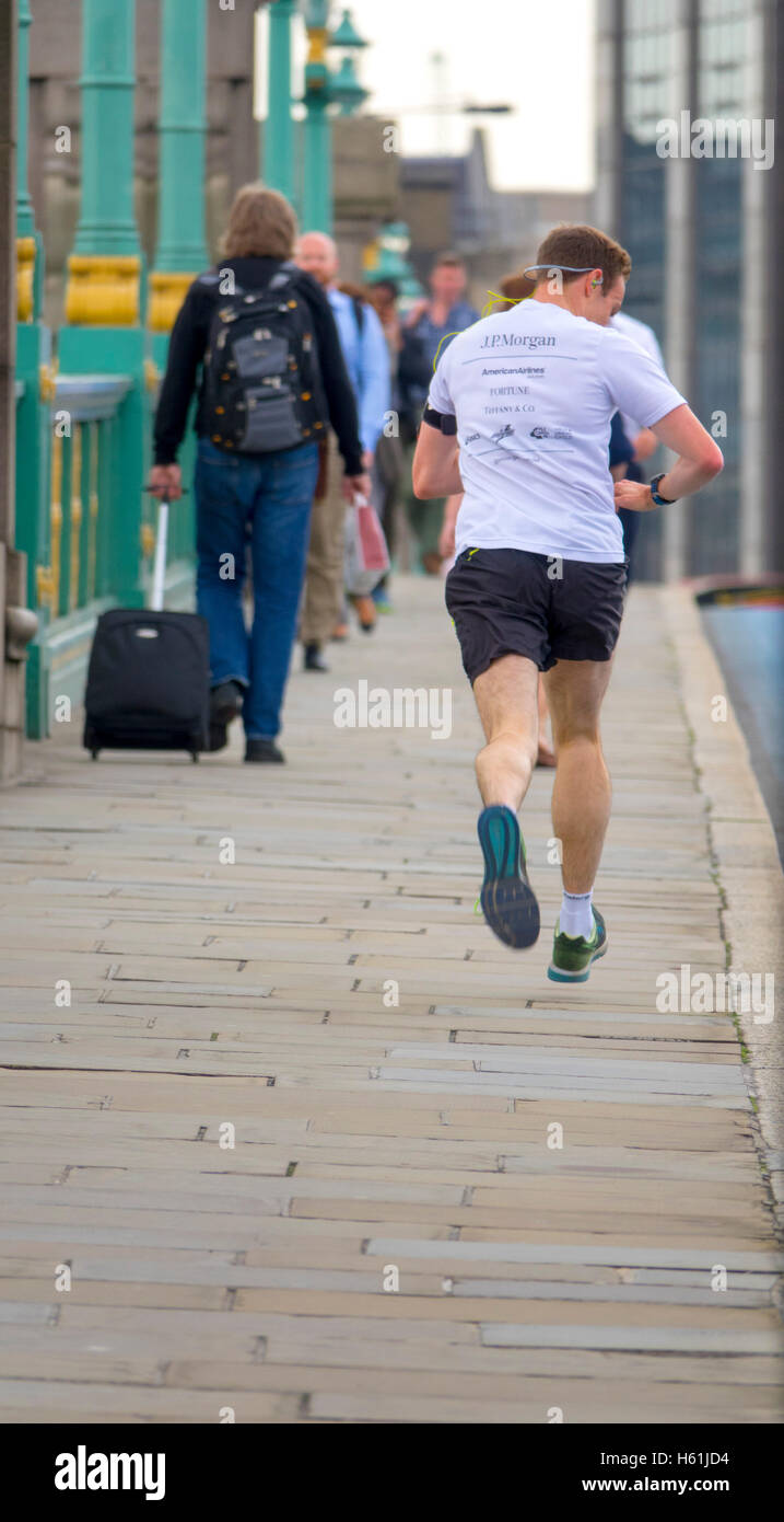 Man running over Southwark Bridge in the City of London Stock Photo - Alamy