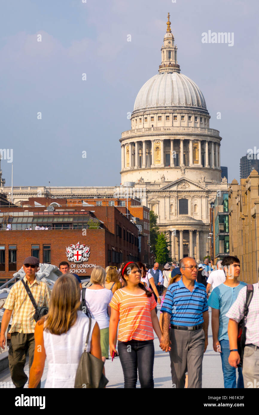 People walking over Millennium Bridge from St Pauls Cathredral Stock ...