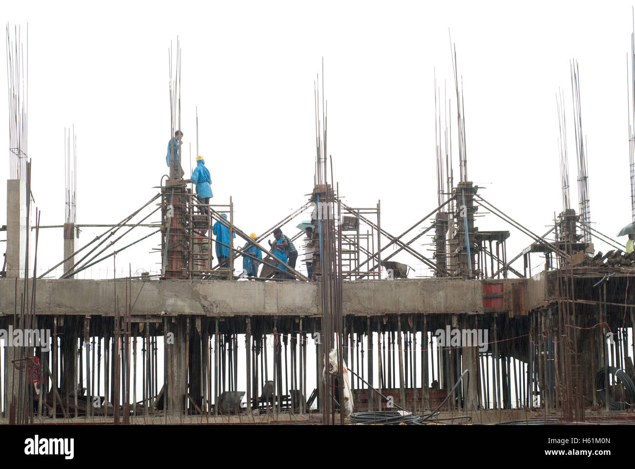 Under construction work going on , concrete iron rods buildings shell ...