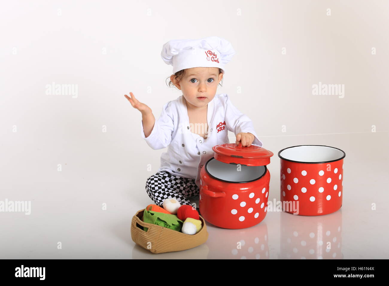 Baby chef with red pots Stock Photo - Alamy