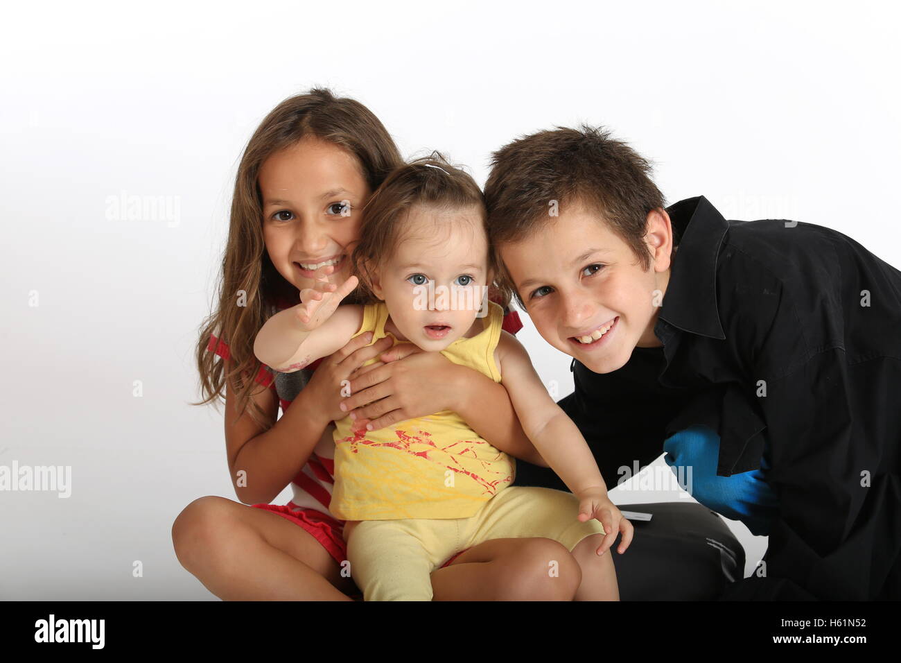 Three smiling young siblings Stock Photo - Alamy