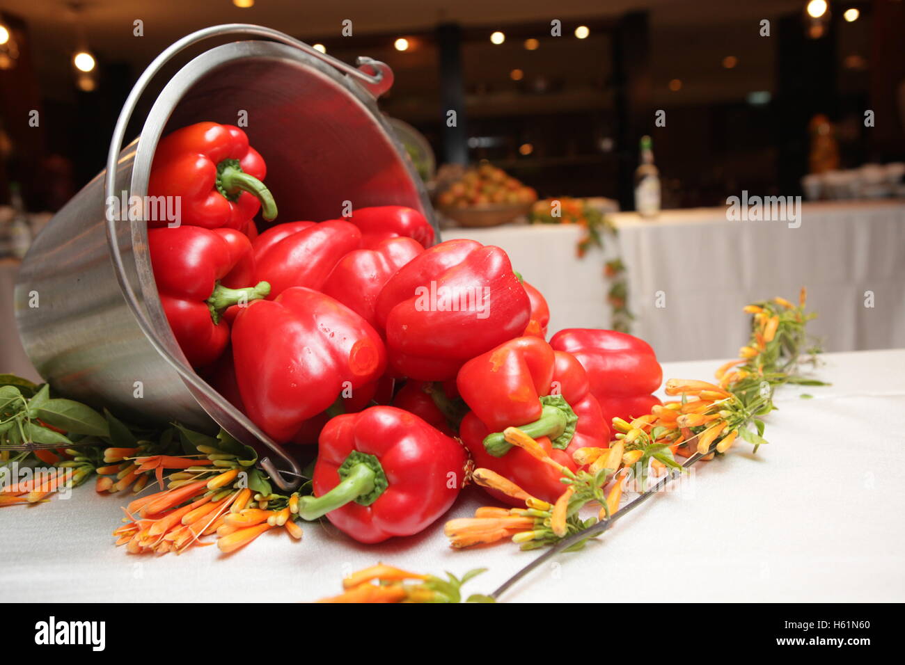 Red bell peppers as a decorative display on a table Stock Photo - Alamy