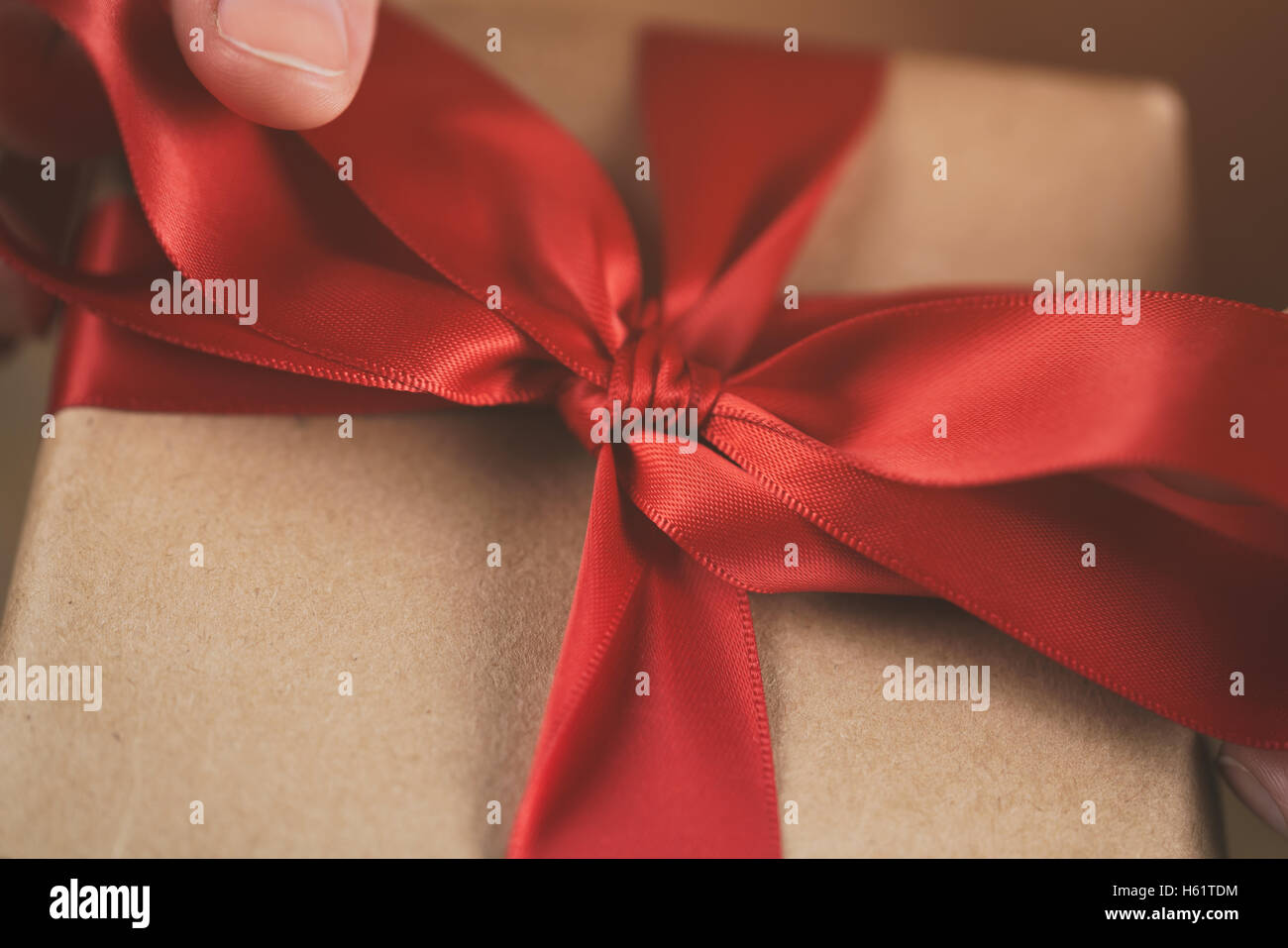 packing gift box with red ribbon Stock Photo - Alamy