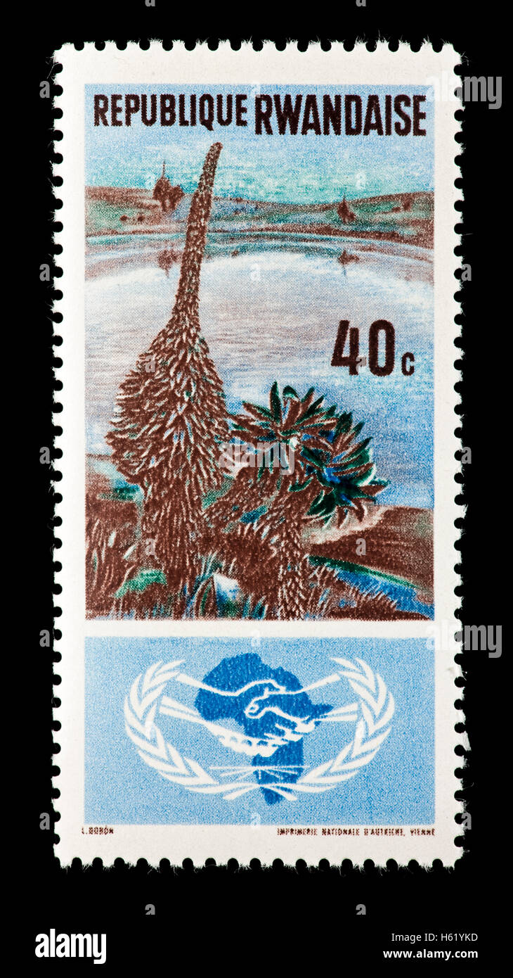 Postage stamp from Rwanda depicting a a tree and lake Stock Photo - Alamy