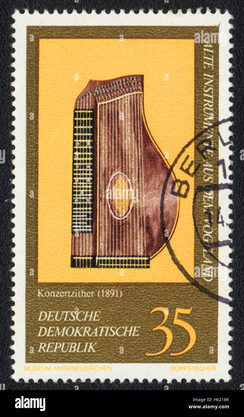 A postage stamp printed in DDR Germany, shows Concert zither, musical ...