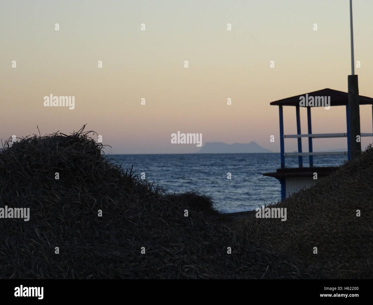 Evening beach scene moonlight Stock Photo - Alamy