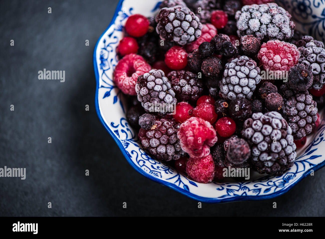Frozen berries fruits in bowl Stock Photo - Alamy