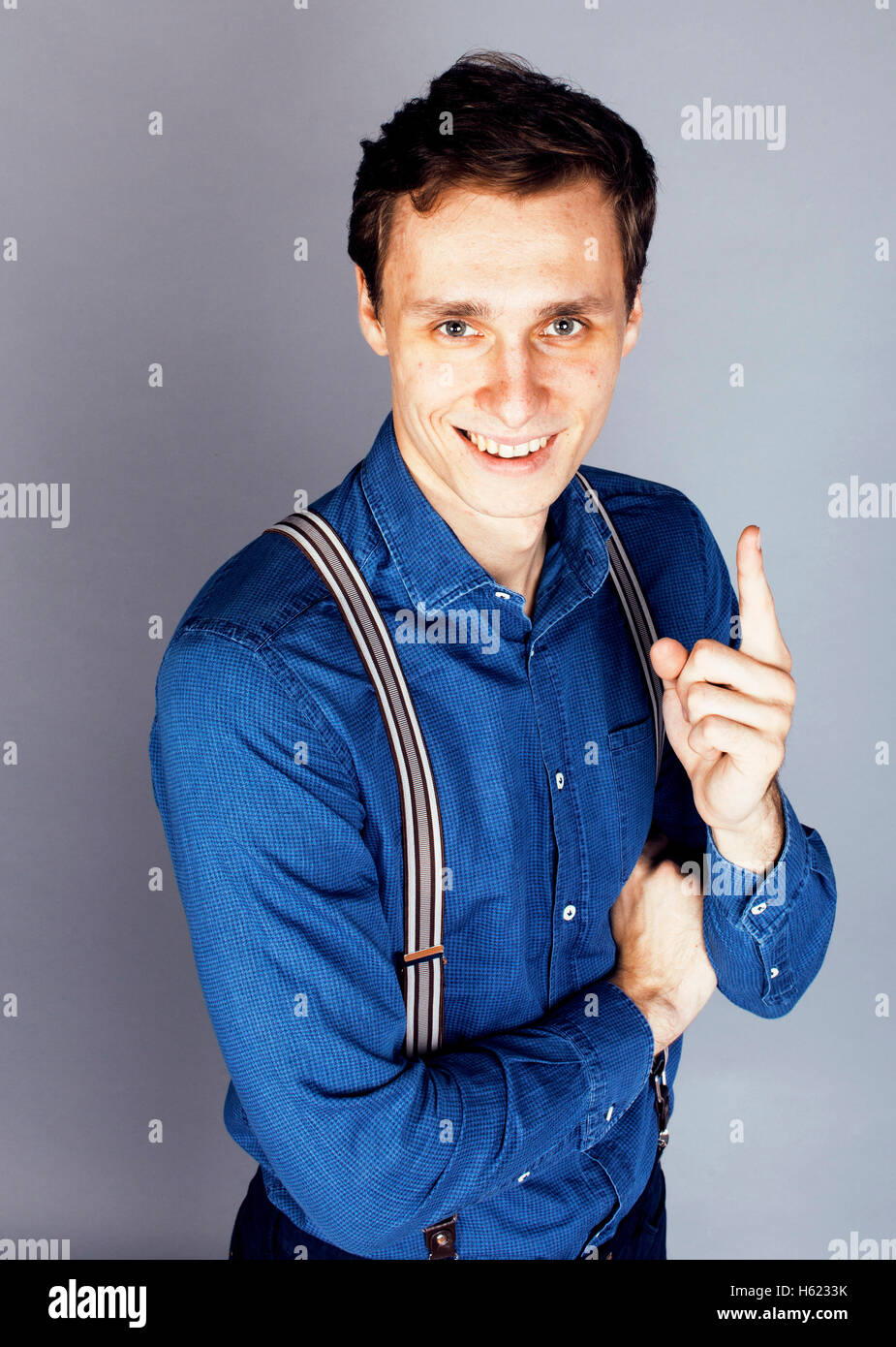 young goofy man with pimples pointing in studio Stock Photo - Alamy
