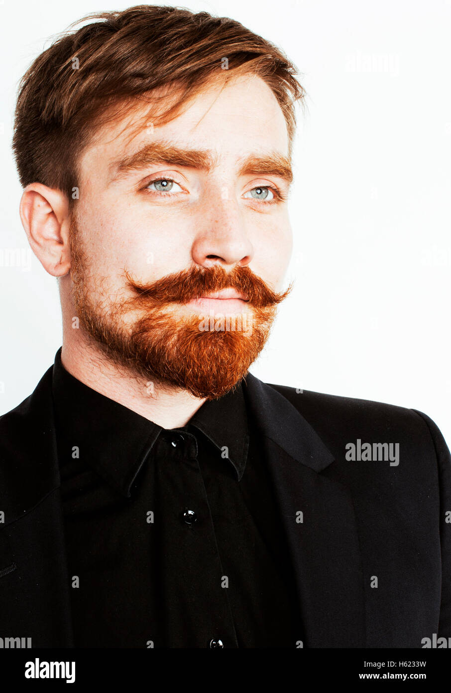 young red hair man with beard and mustache in black suit on whit Stock ...