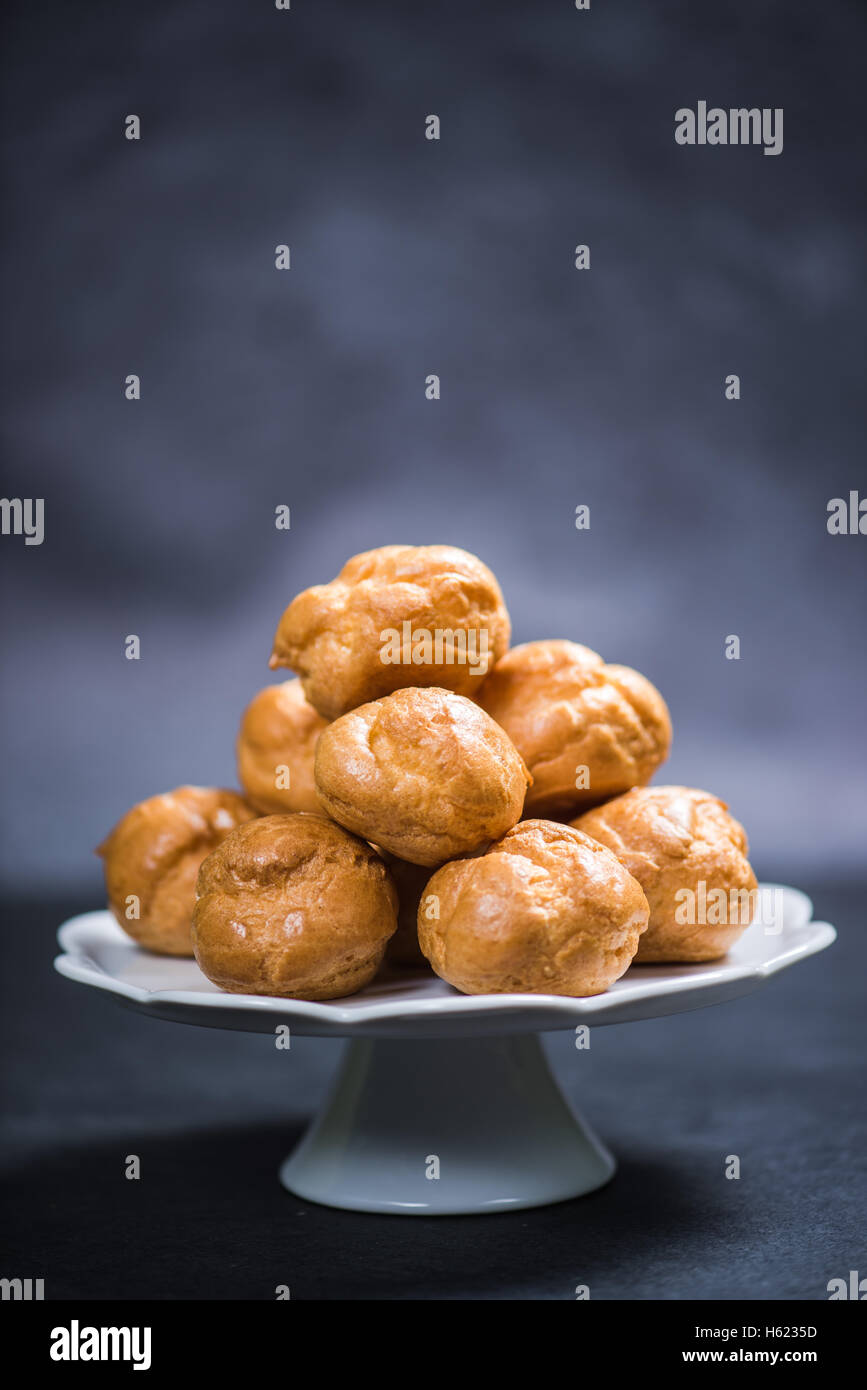 Profiterole eclair stack on platter Stock Photo - Alamy