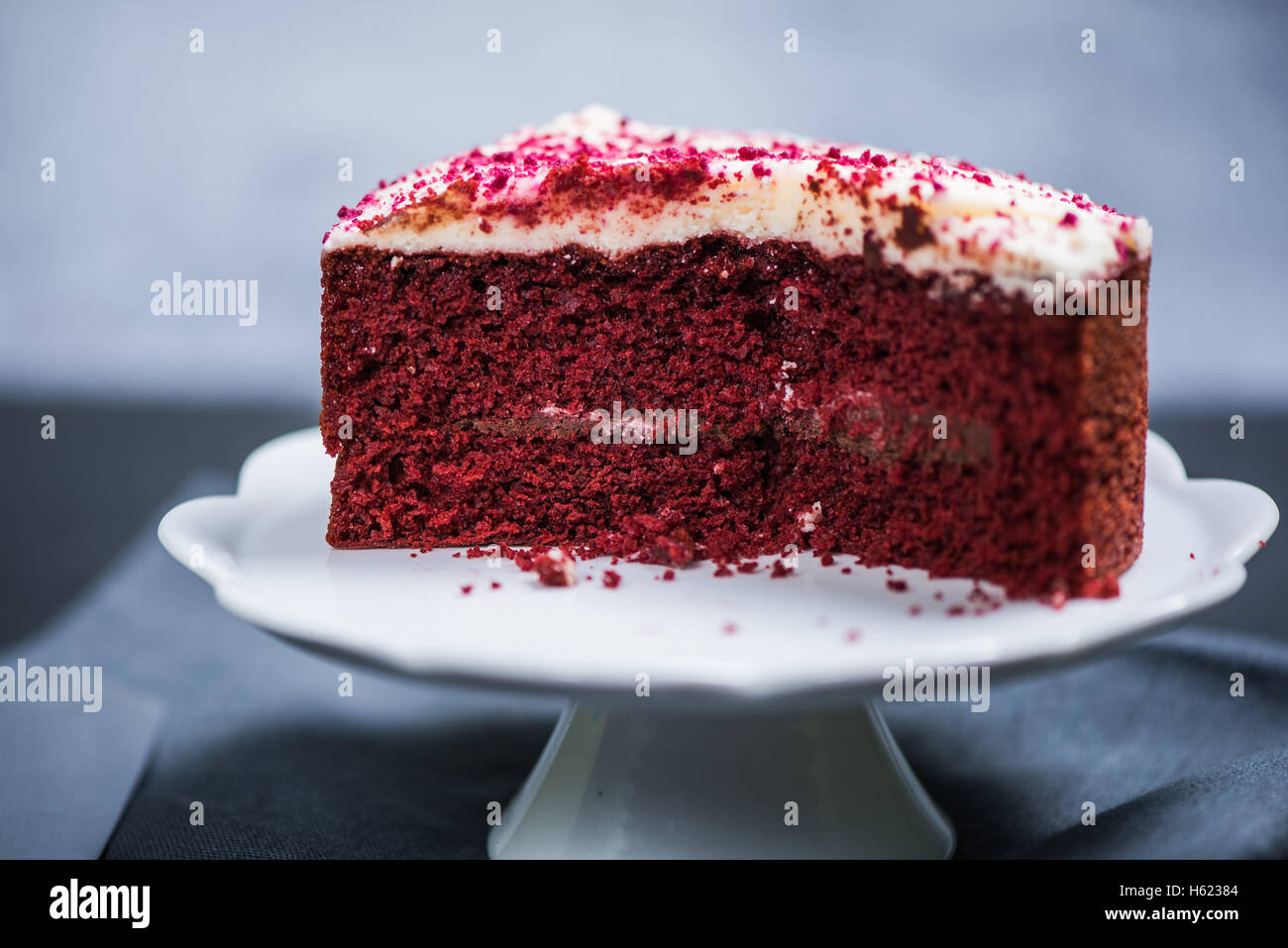 Red velvet sponge cake cut, with icing sugar top Stock Photo - Alamy