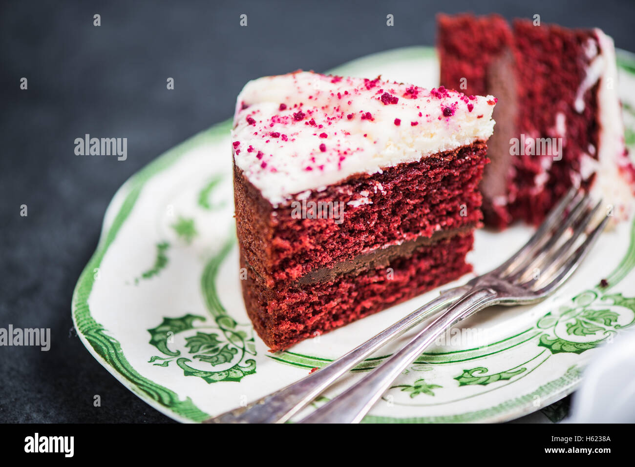 Slice of red velvet sponge cake on serving plate Stock Photo - Alamy