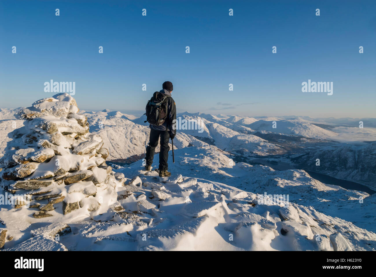 Hillwalker on Beinn Odhar Mhor (Corbett top) summit looking towards ...