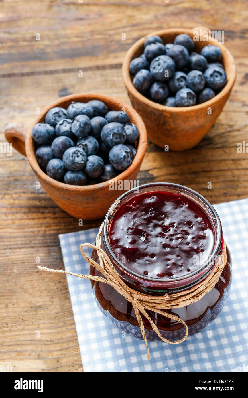 Jar of blueberry jam and bowls of blueberries. Party dessert Stock ...