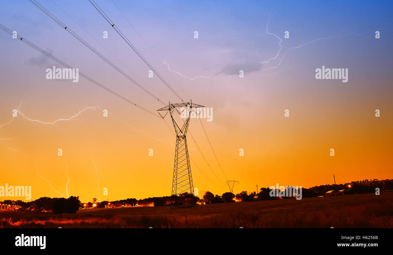 high voltage pylon with lightning in the sky in the night Stock Photo ...