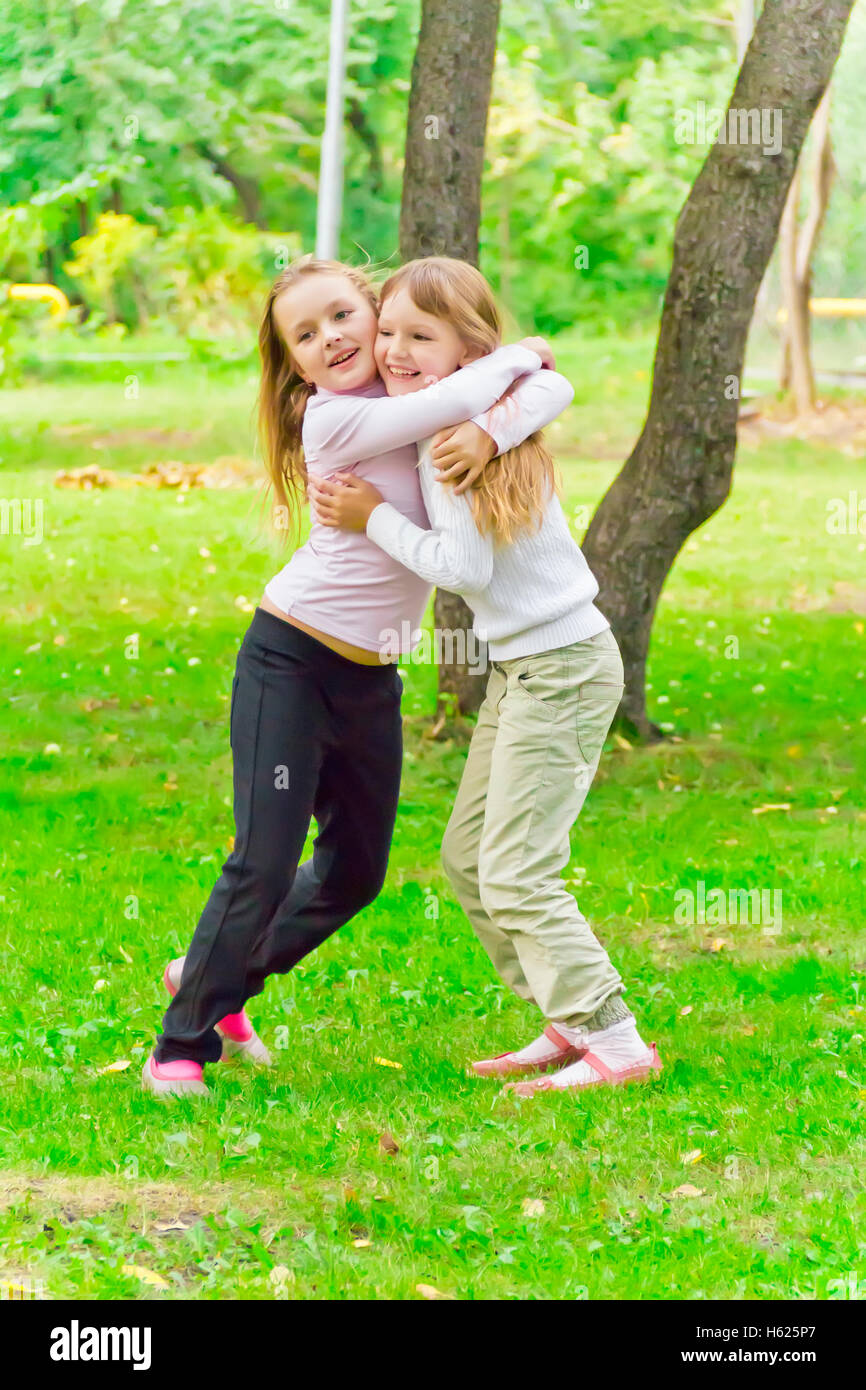Cute two embracing girls Stock Photo - Alamy