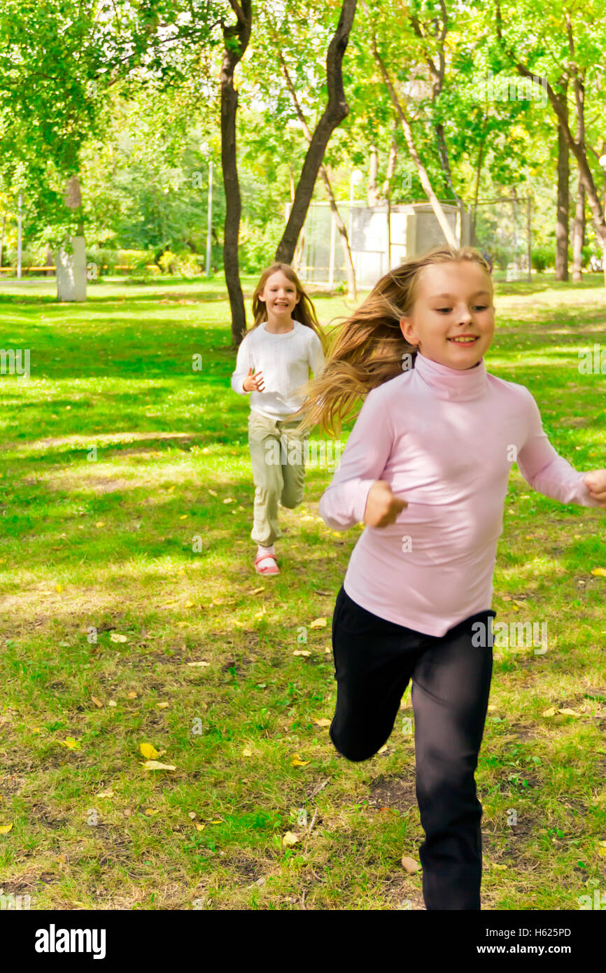 Cute two running girls Stock Photo - Alamy
