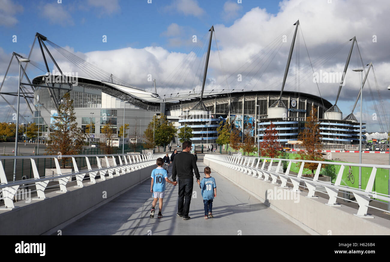 Fans walk to the Etihad Stadium in Manchester before the Manchester ...