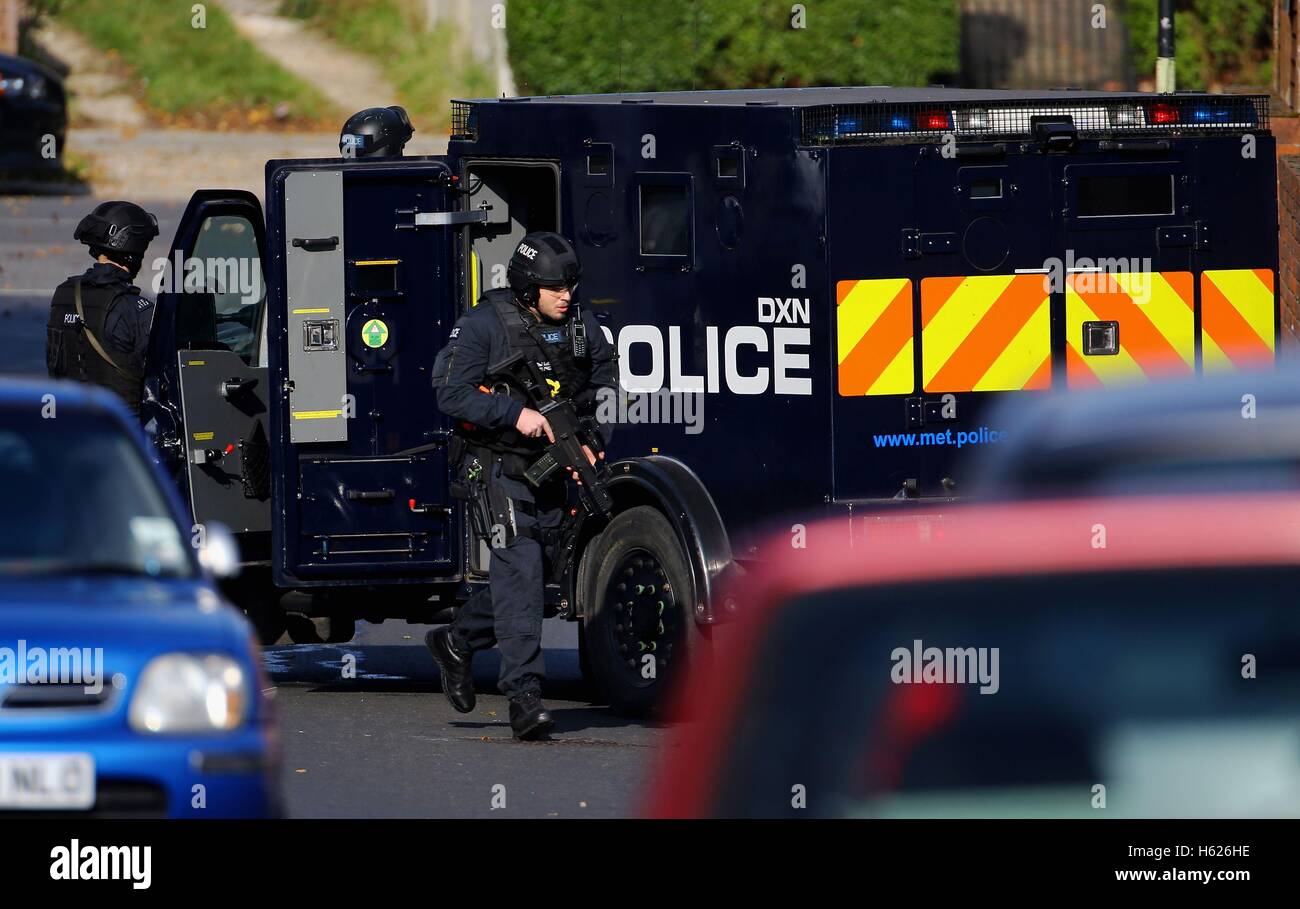 Armed police officers at the scene in Northolt, London, where they ...