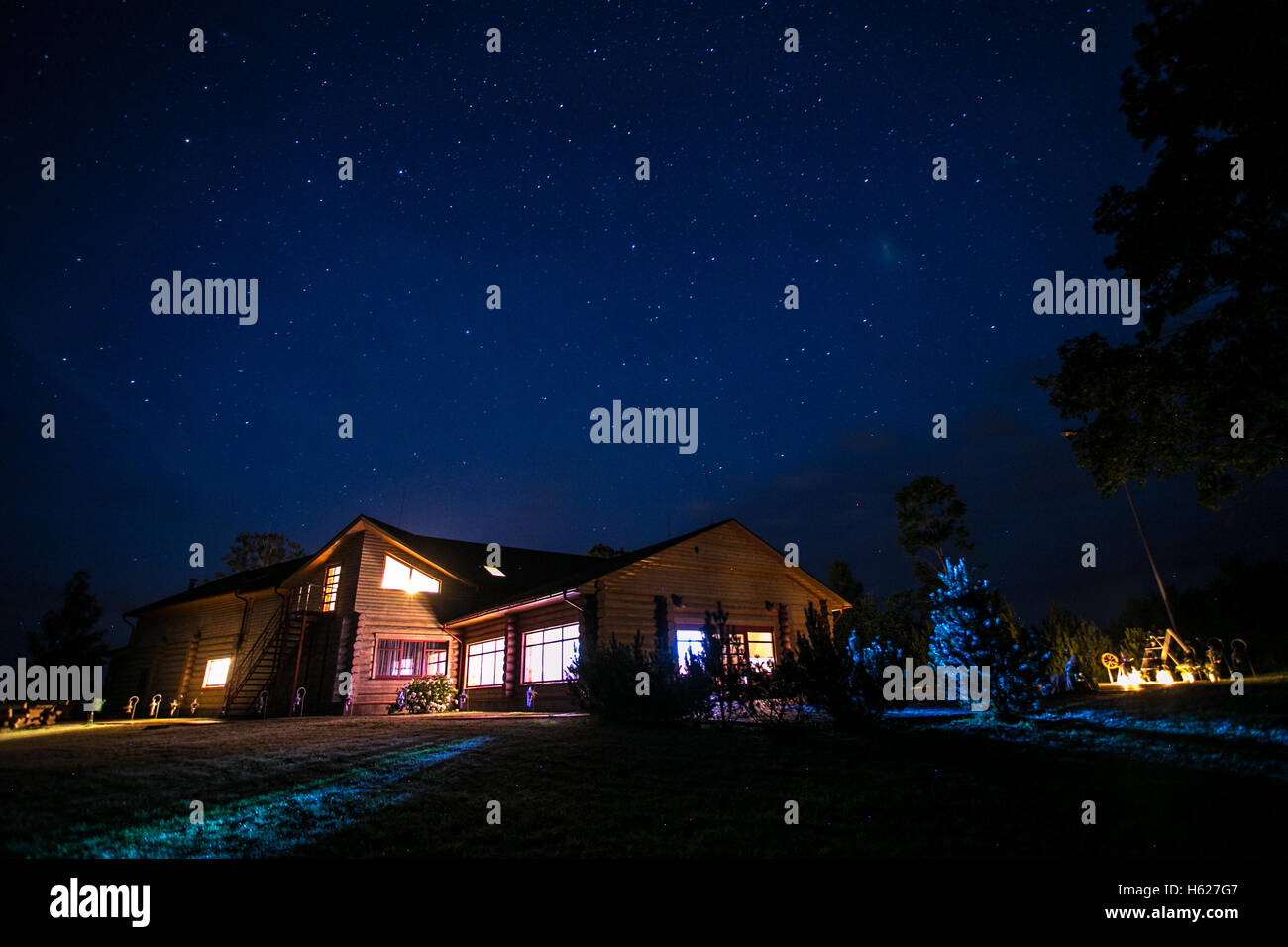 Cottage house at night with stars Stock Photo - Alamy