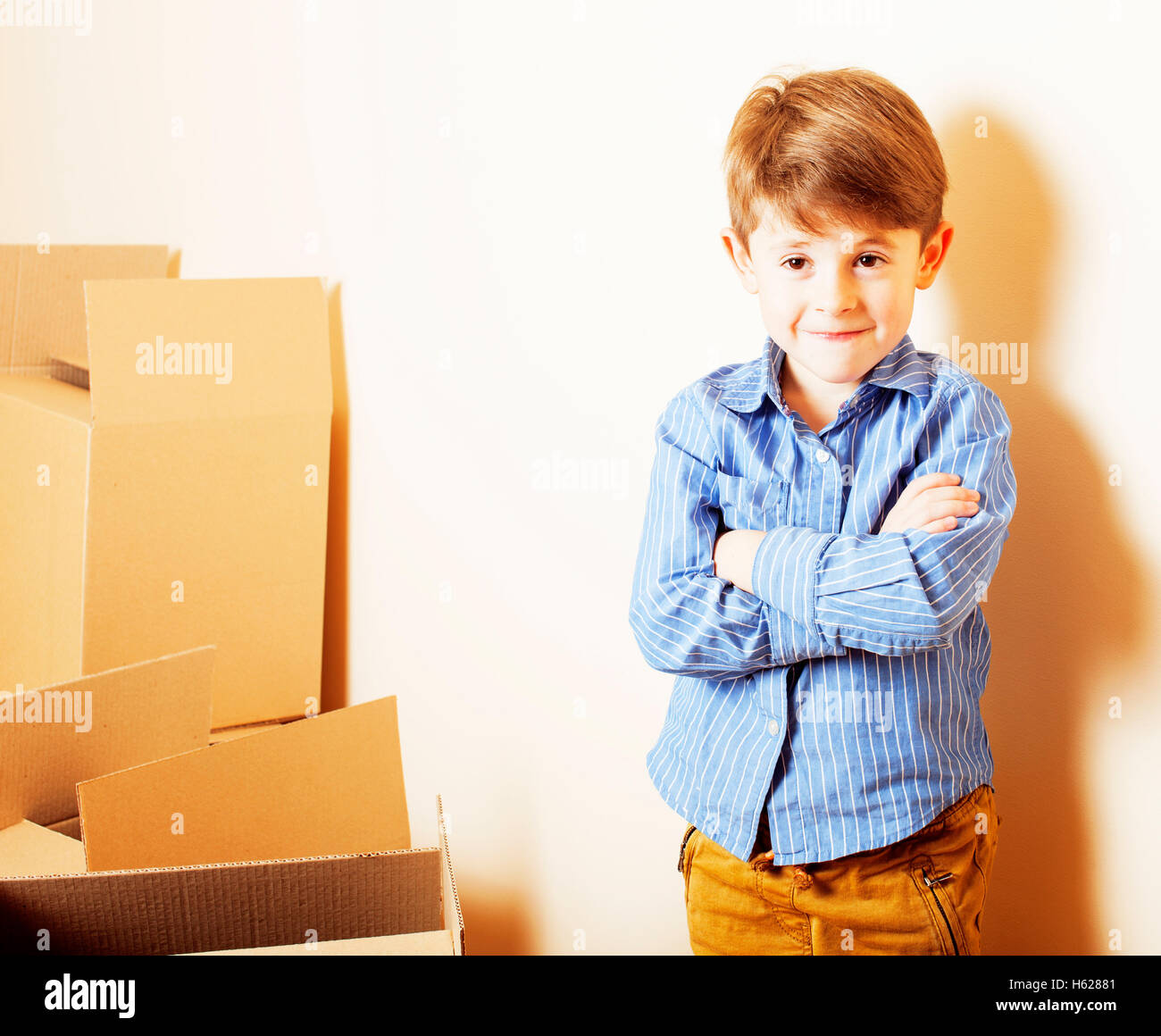 little cute boy in empty room, remoove to new house. home alone Stock ...