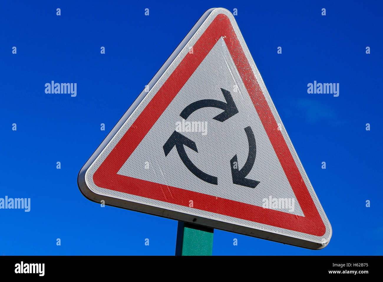 roundabout road sign on blue sky Stock Photo - Alamy