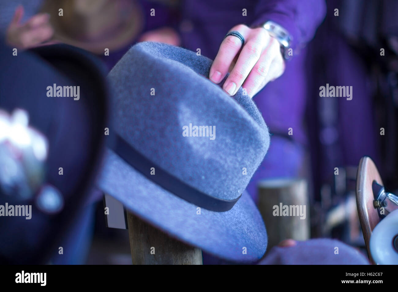 Hand taking hat in store Stock Photo - Alamy