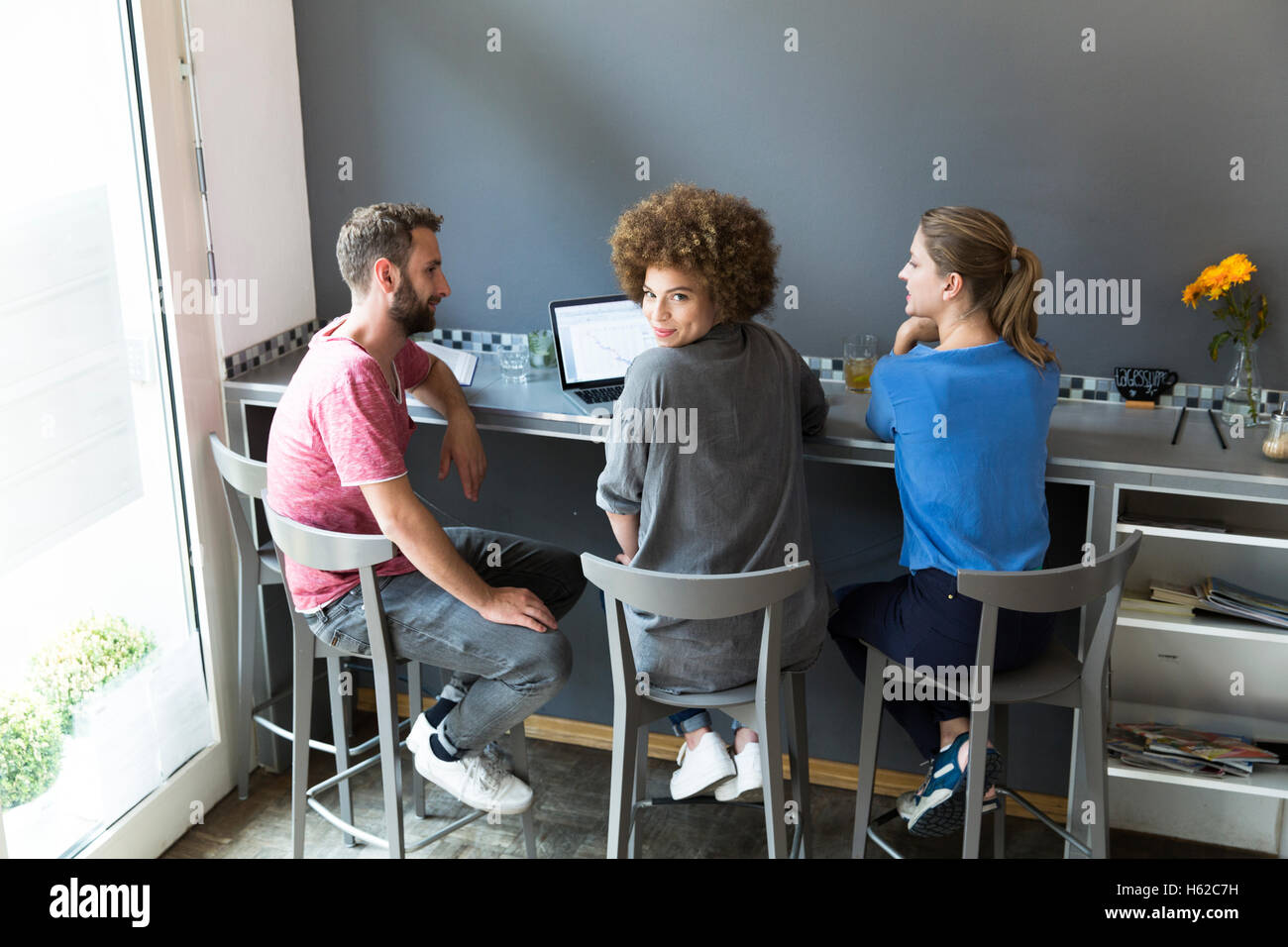 Three people in a bar talking hi-res stock photography and images - Alamy