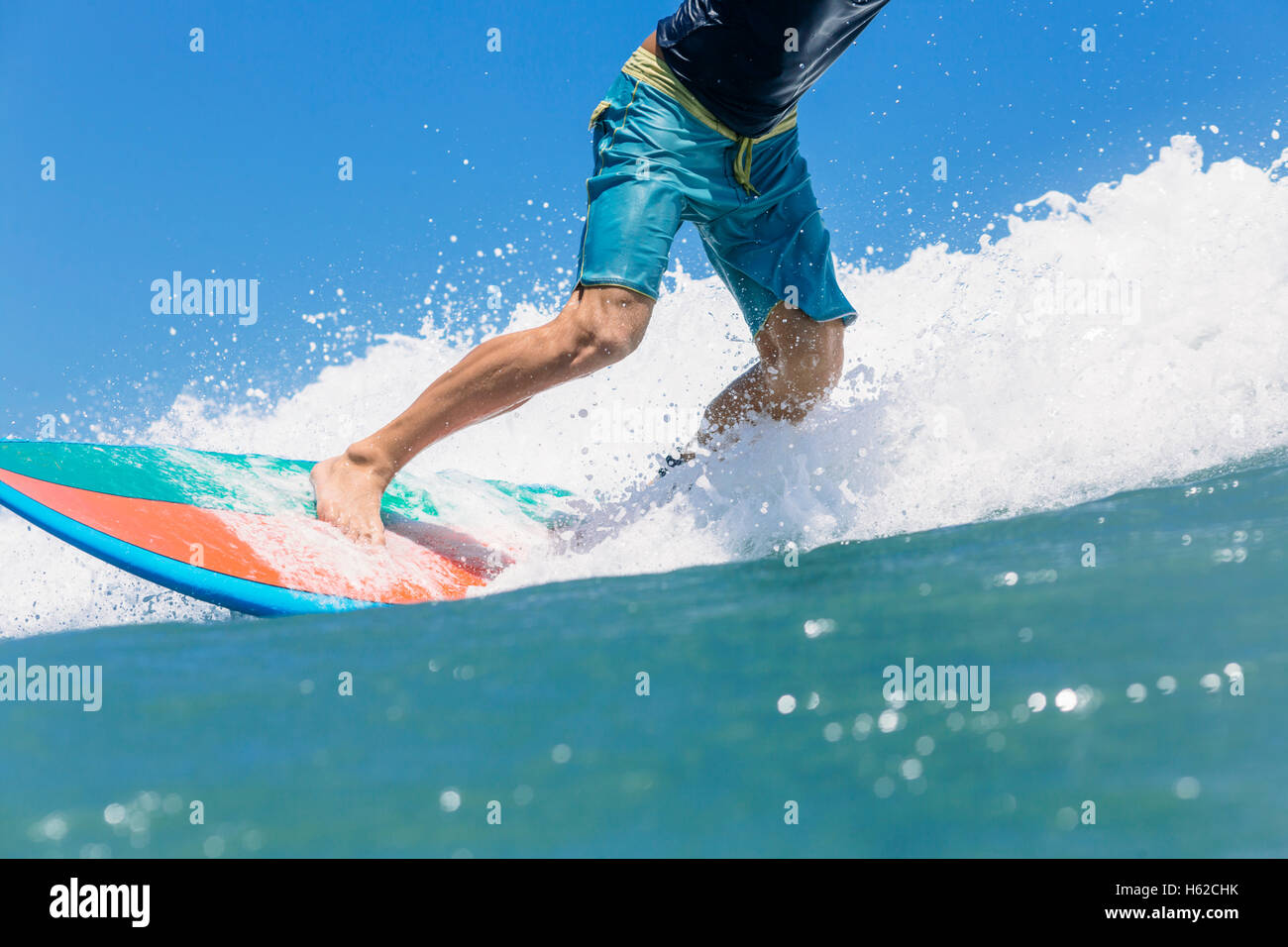Indonesia, Bali, surfer standing on surfboard Stock Photo - Alamy