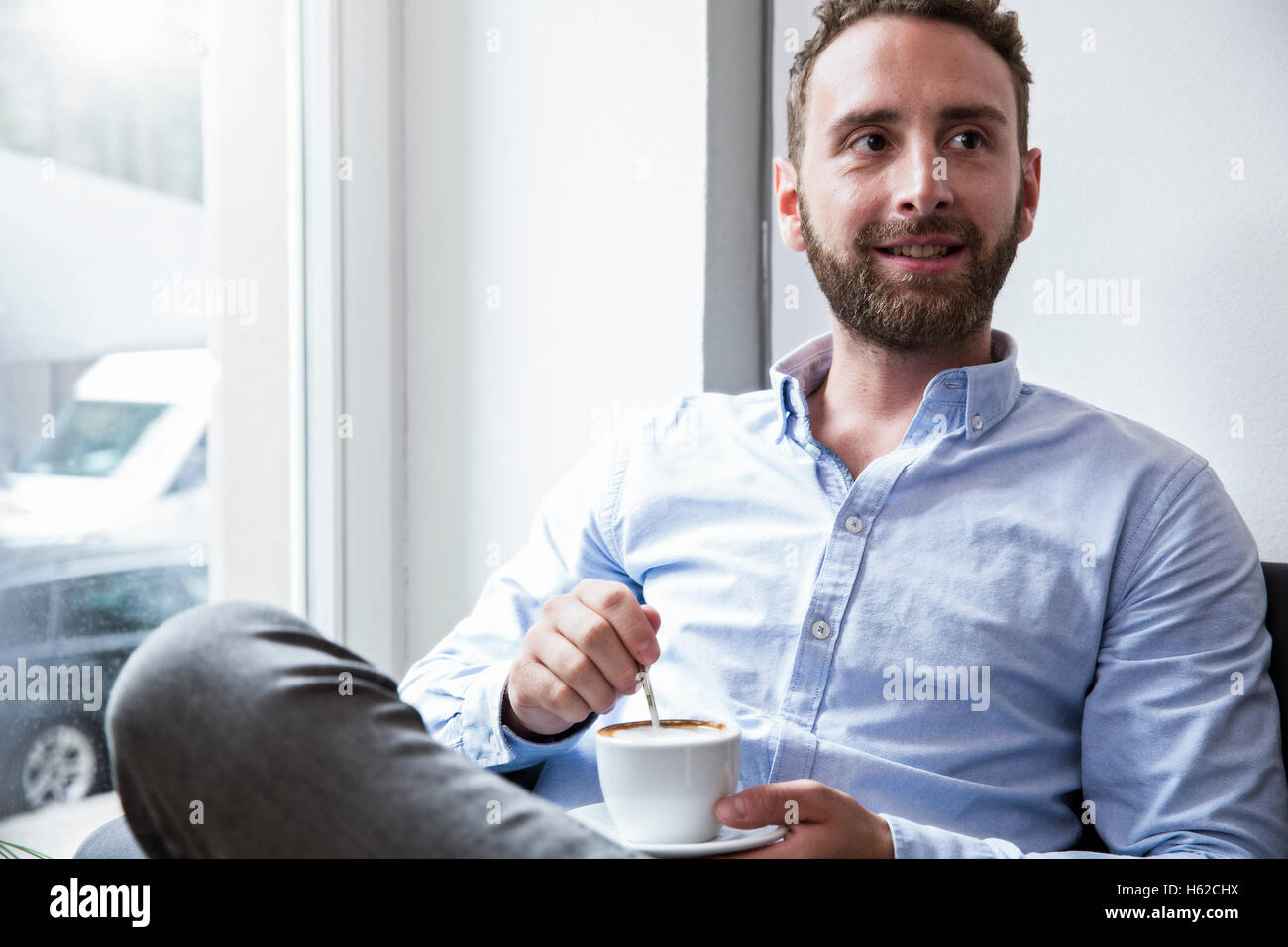 Young man with coffee cup hi-res stock photography and images - Alamy